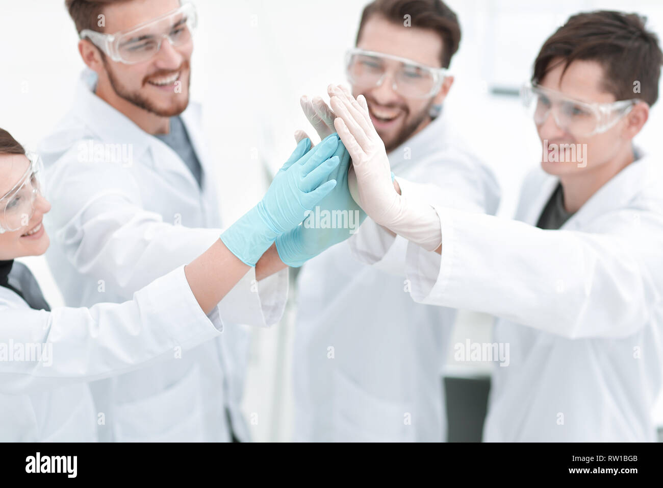 scientists giving each other a high five Stock Photo - Alamy