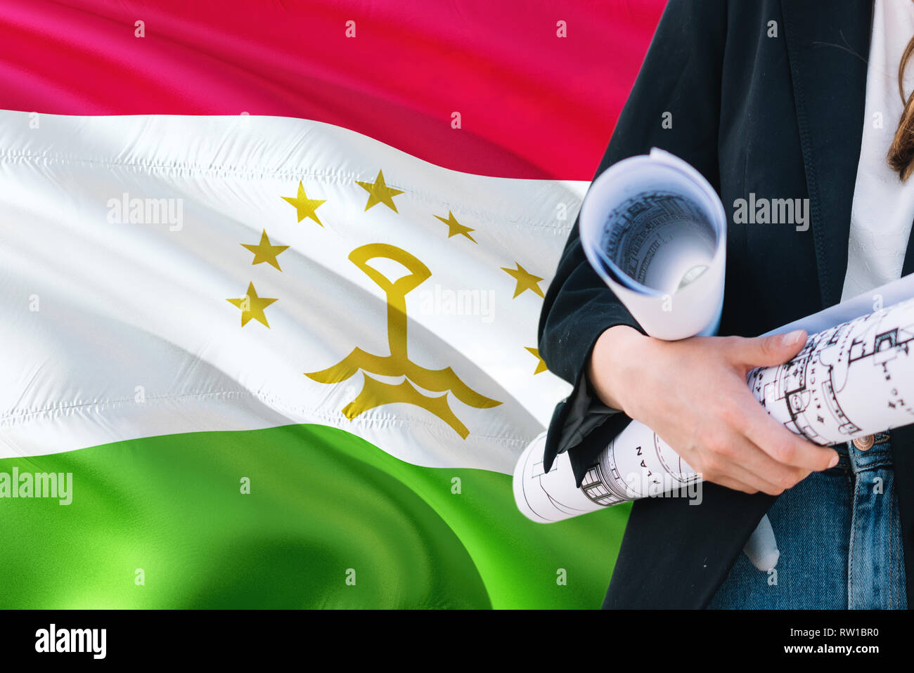 Tajik Architect woman holding blueprint against Tajikistan waving flag ...