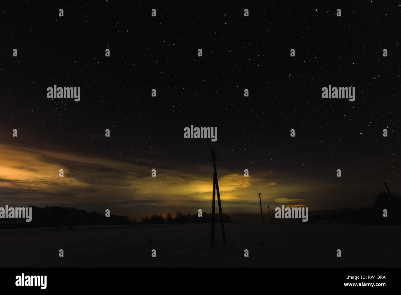dark sky with yellow illumination in carpathian mountains at night ...