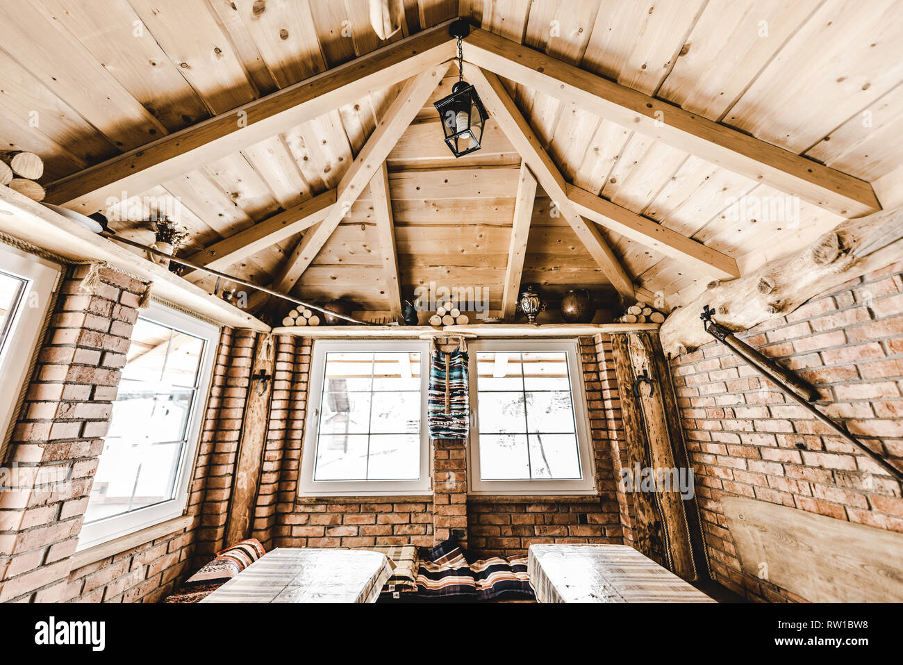 interior of wooden rural cottage with windows and brick walls Stock ...