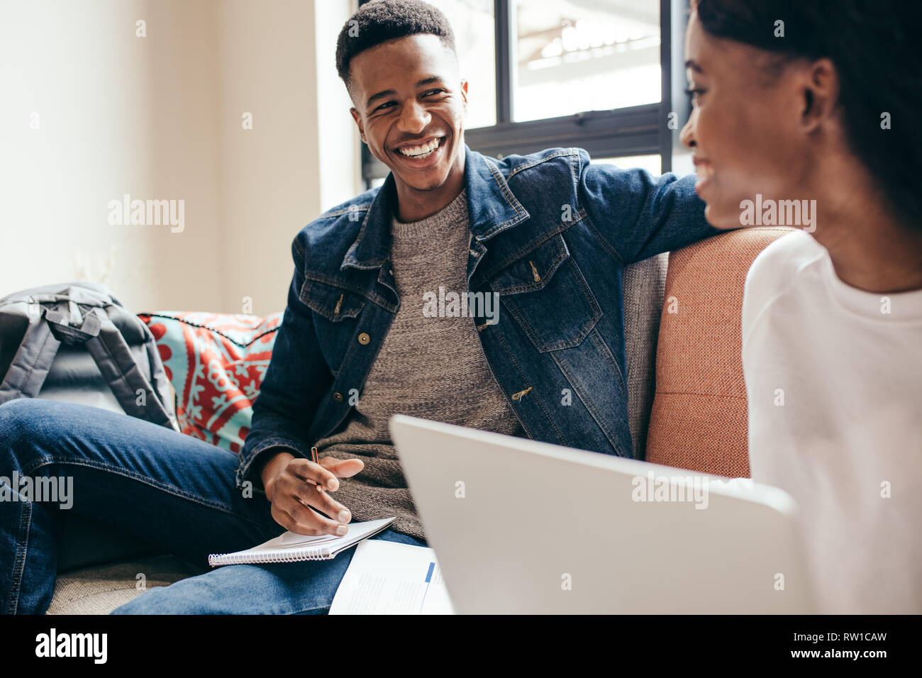 African man with his classmate at college campus. Two young people ...