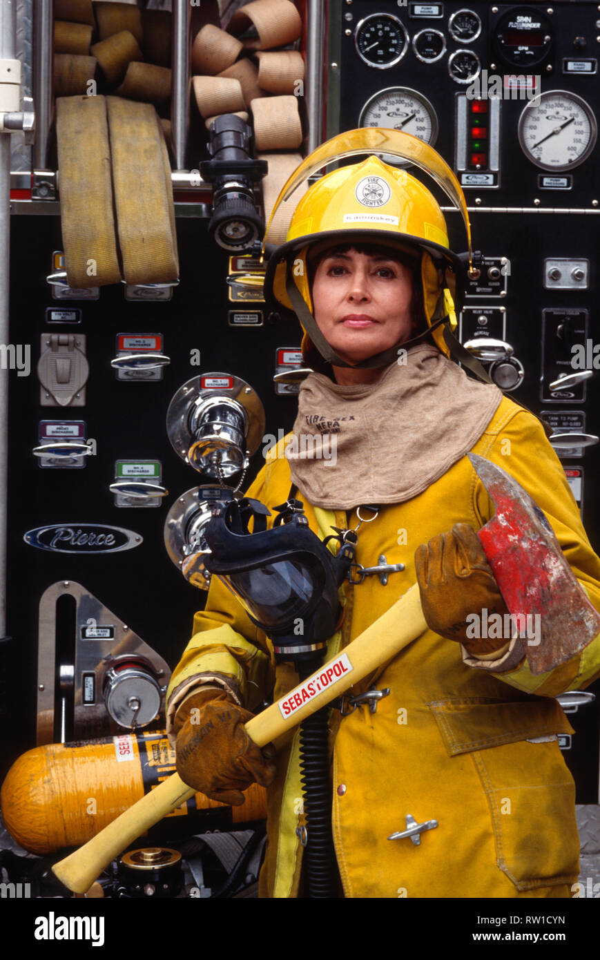 Female Hispanic Firefighter Poses in front of a Fire Truck, California ...