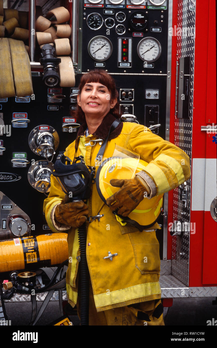Female Hispanic Firefighter Poses in front of a Fire Truck, California ...