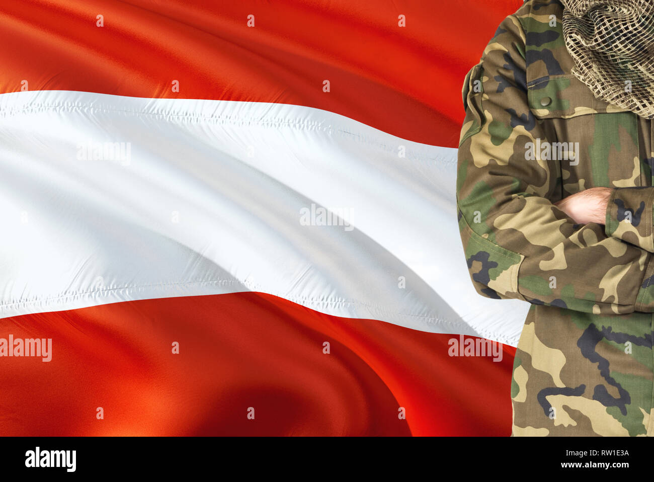 Crossed arms Austrian soldier with national waving flag on background ...