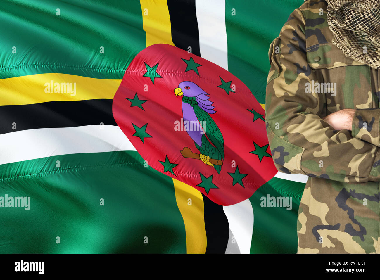 Crossed arms Dominican soldier with national waving flag on background ...