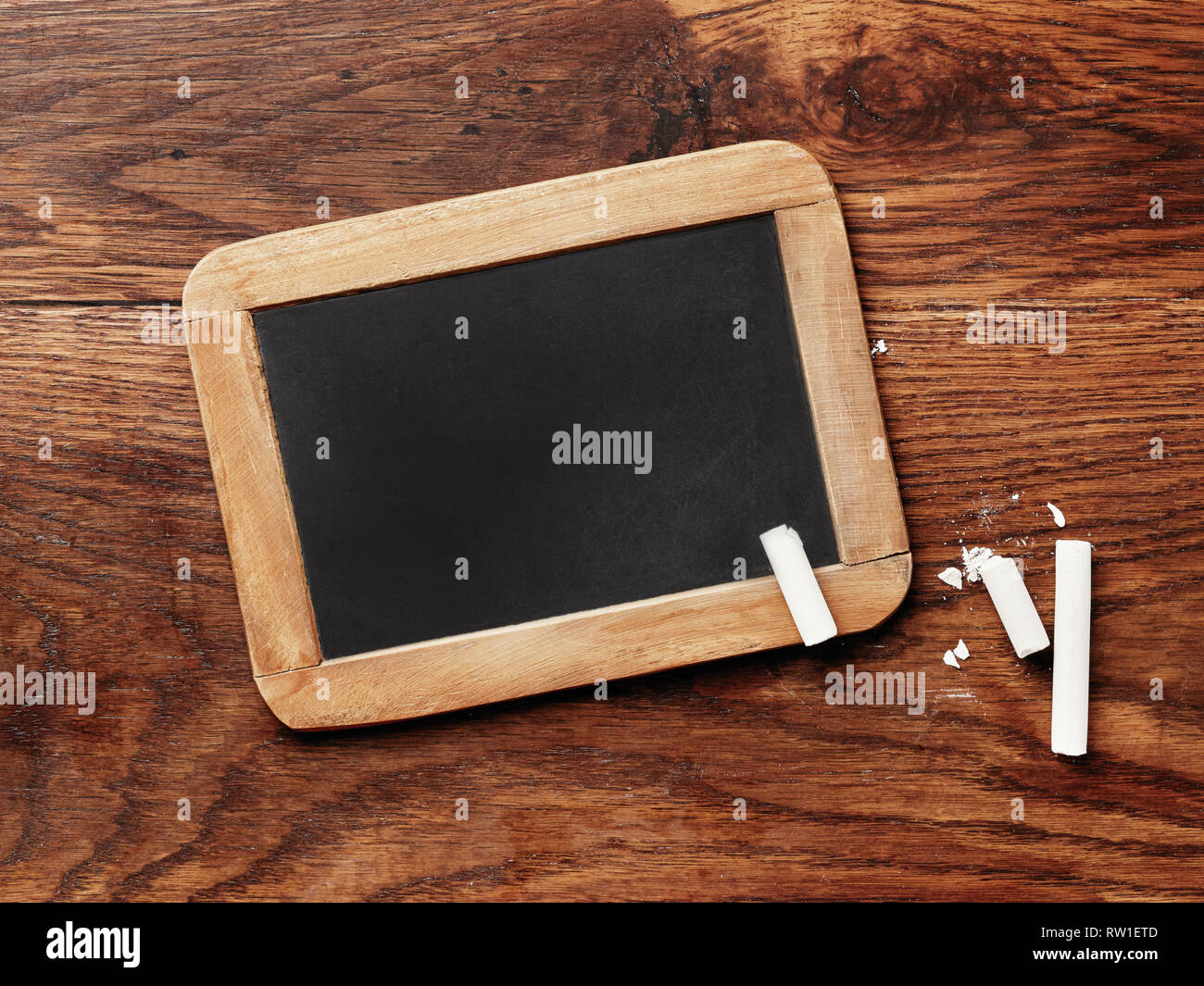 Chalk board and chalk on wooden table. Mockup for calligraphy and ...