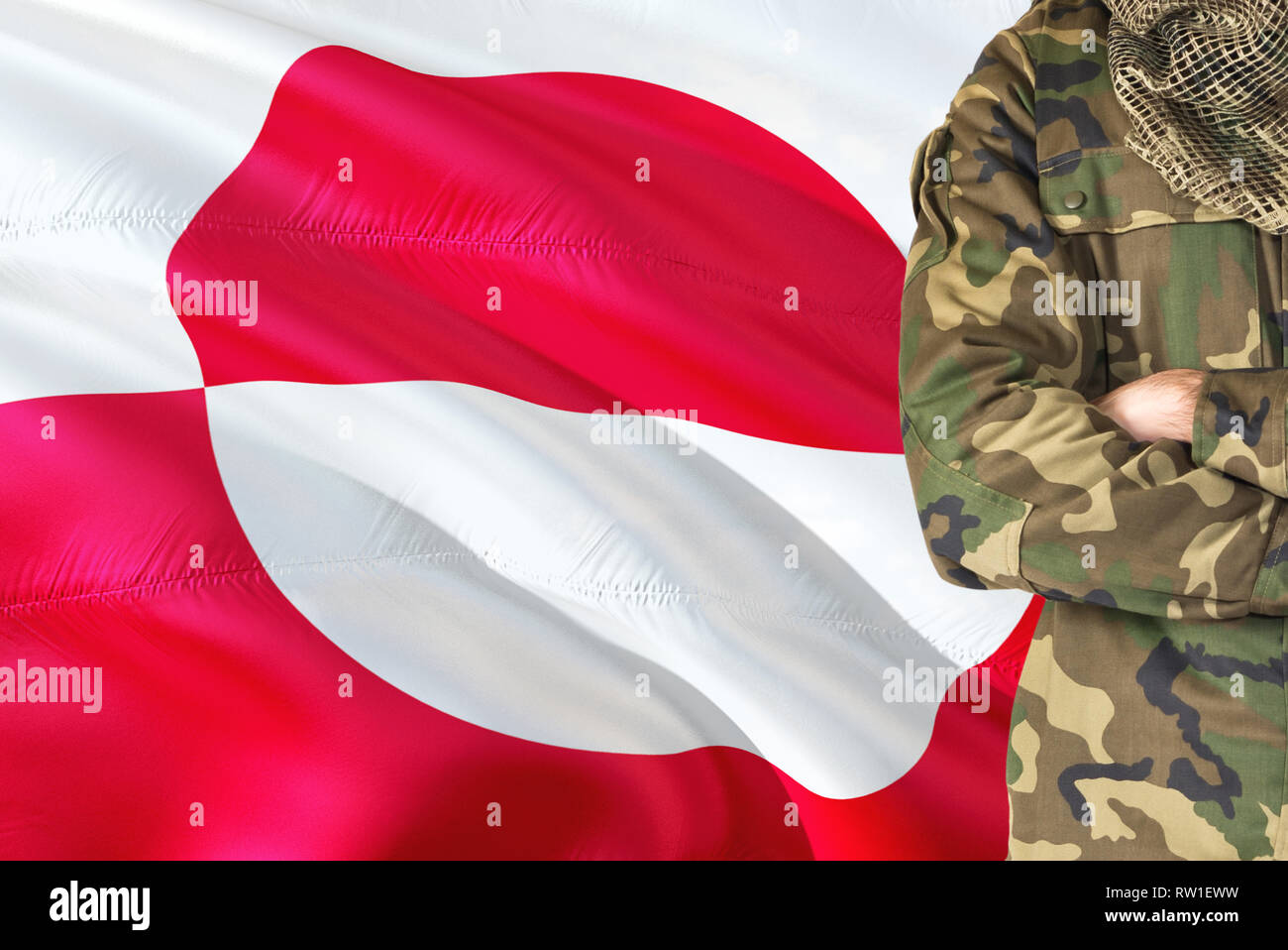Crossed arms soldier with national waving flag on background ...