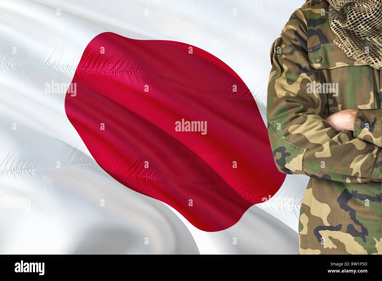 Crossed arms Japanese soldier with national waving flag on background ...