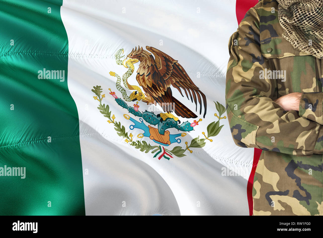 Crossed arms Mexican soldier with national waving flag on background ...