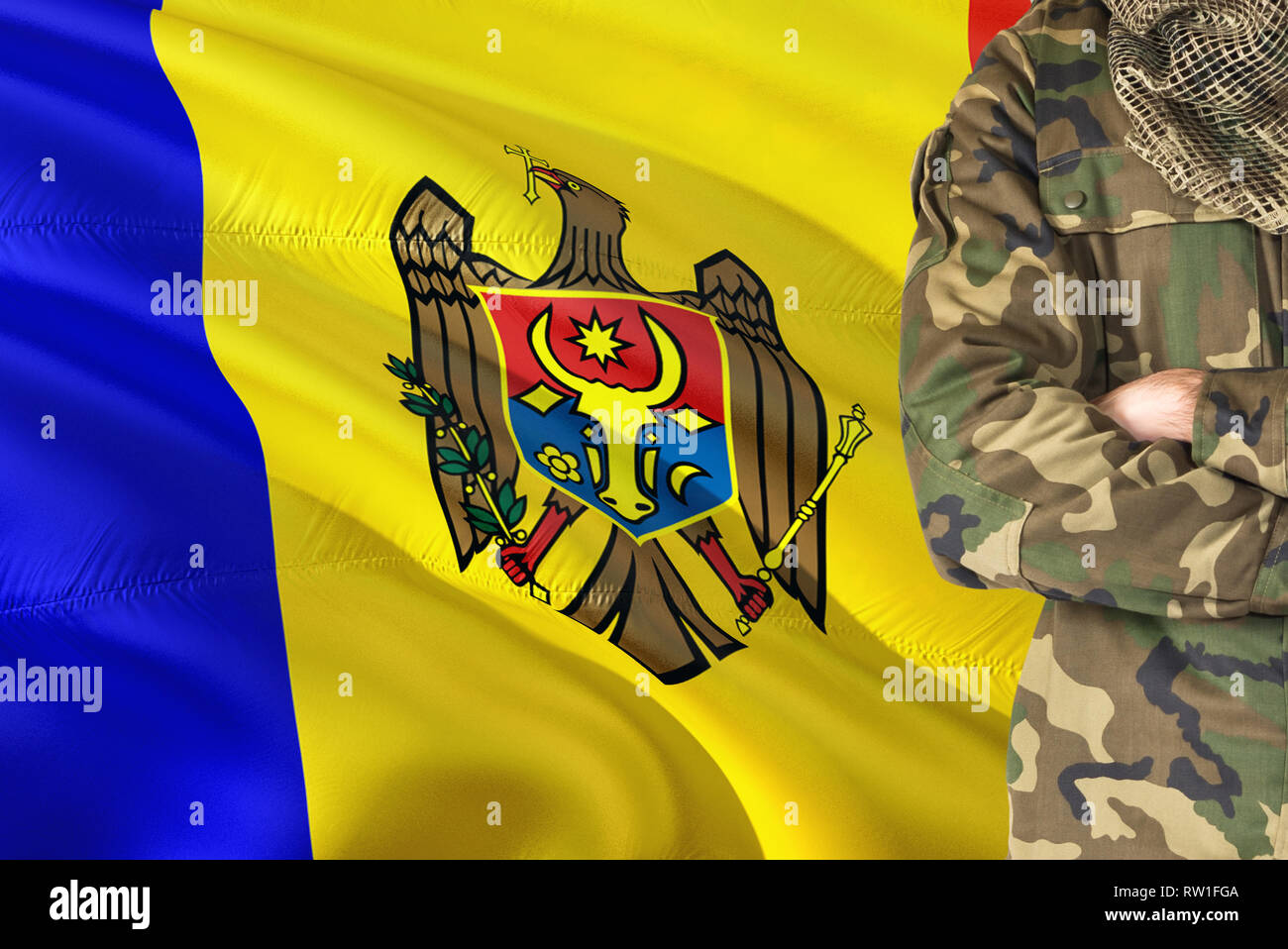Crossed arms Moldovan soldier with national waving flag on background ...