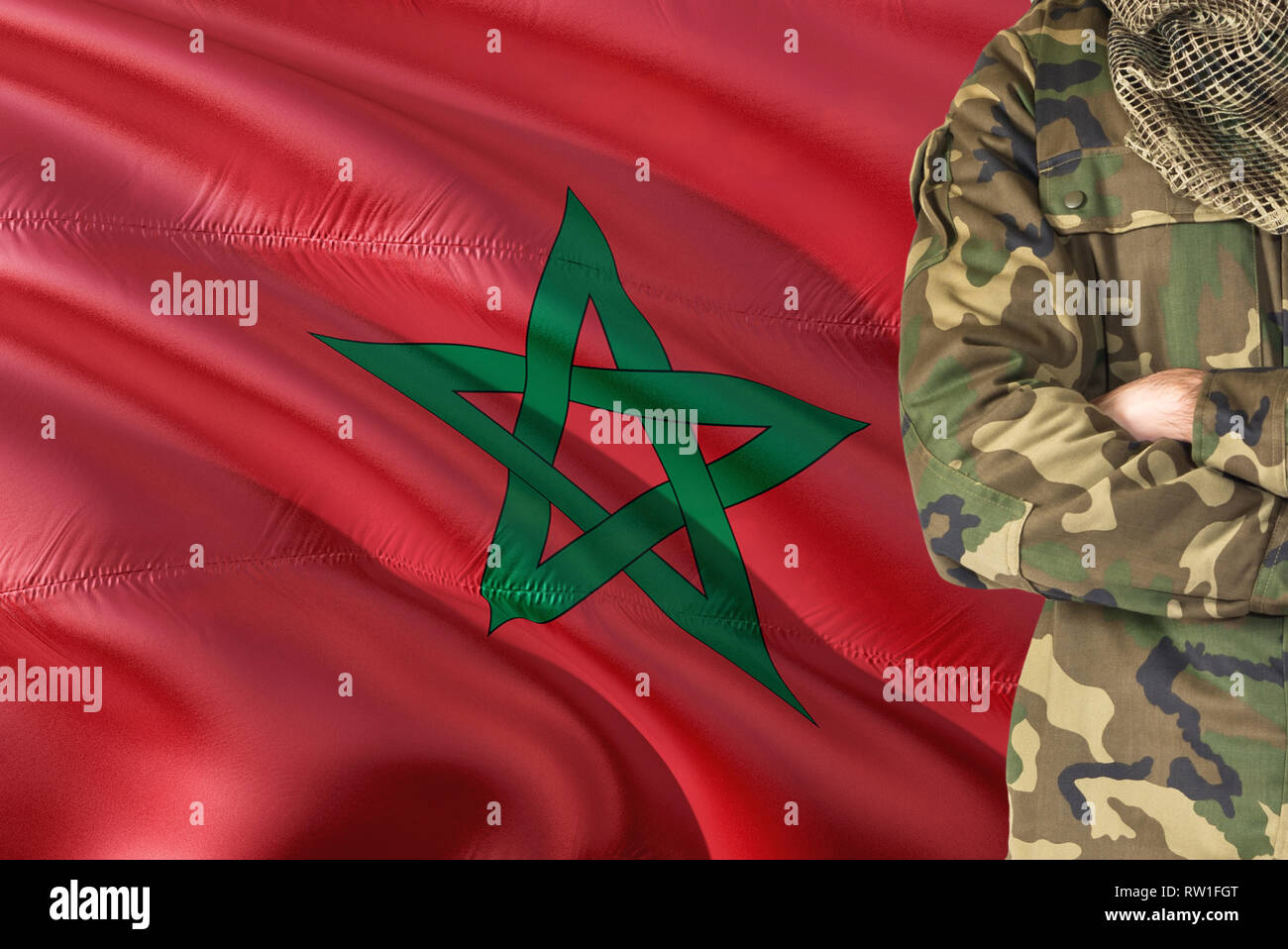 Crossed arms Moroccan soldier with national waving flag on background ...