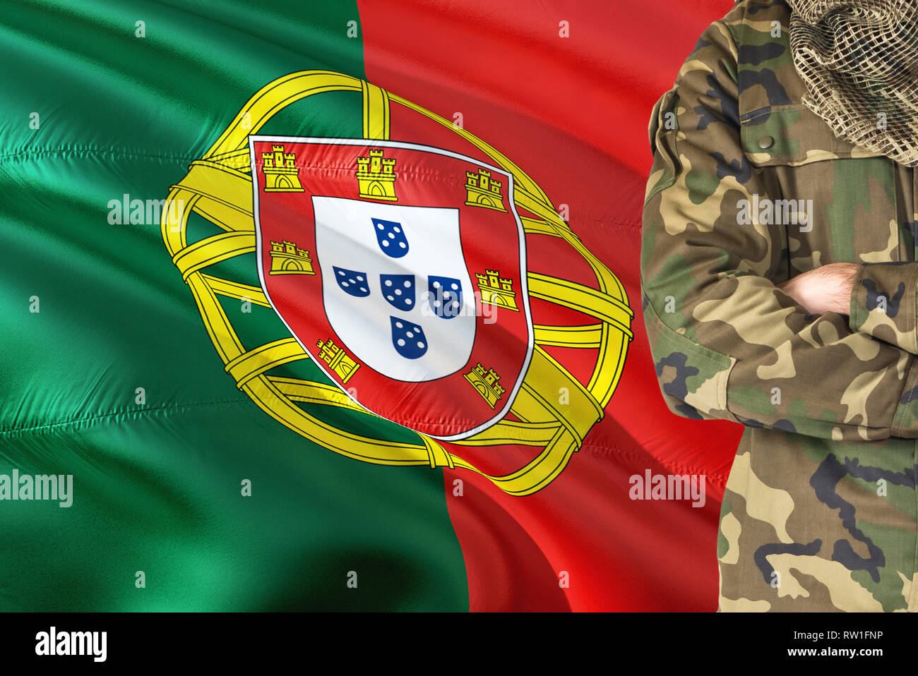 Crossed arms Portuguese soldier with national waving flag on background ...