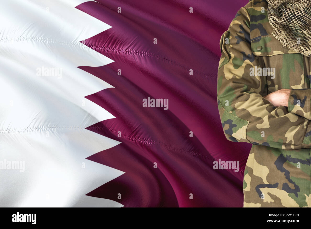 Crossed arms Qatari soldier with national waving flag on background ...