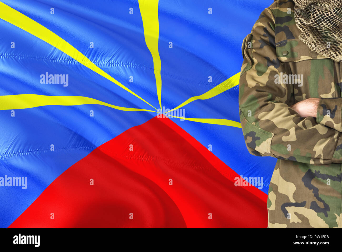 Crossed arms soldier with national waving flag on background - Reunion ...