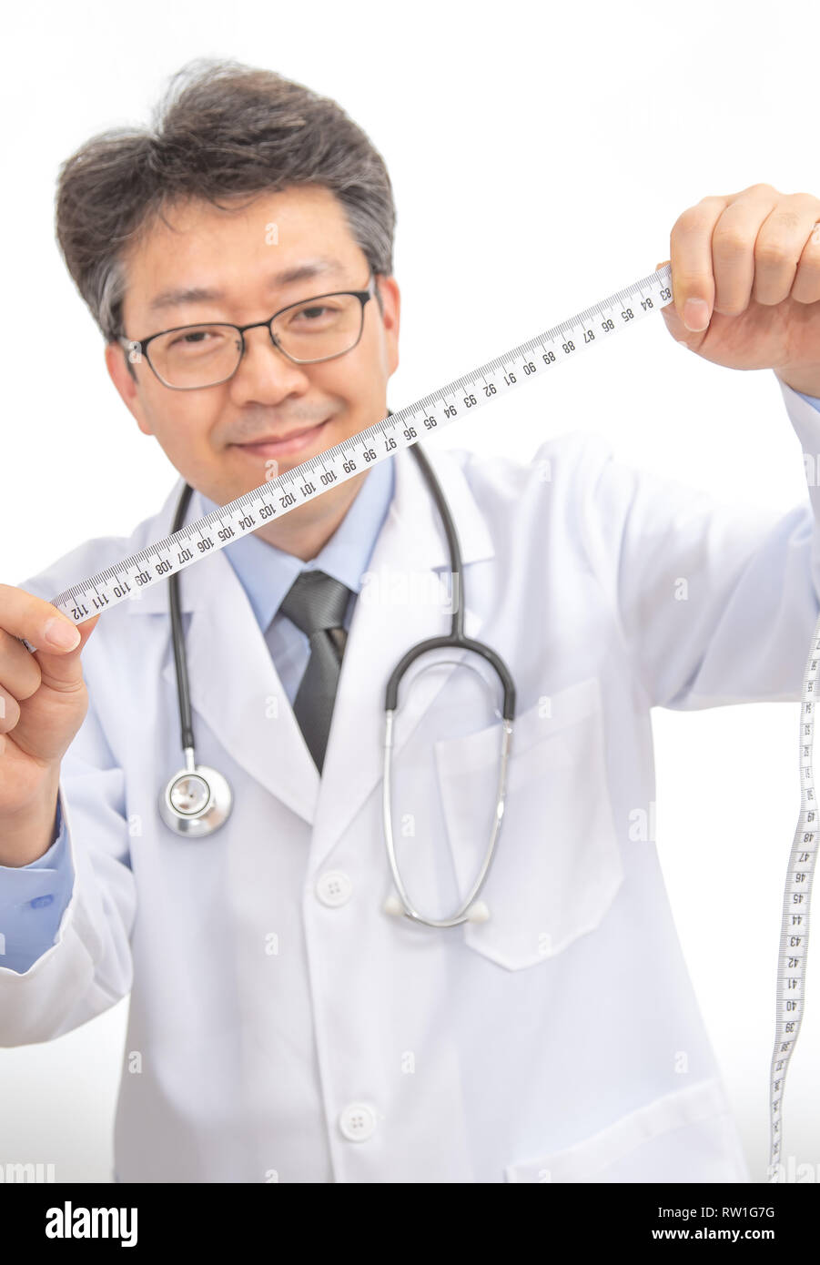an Asian doctor with a tape measure in his hand. isolated on white ...