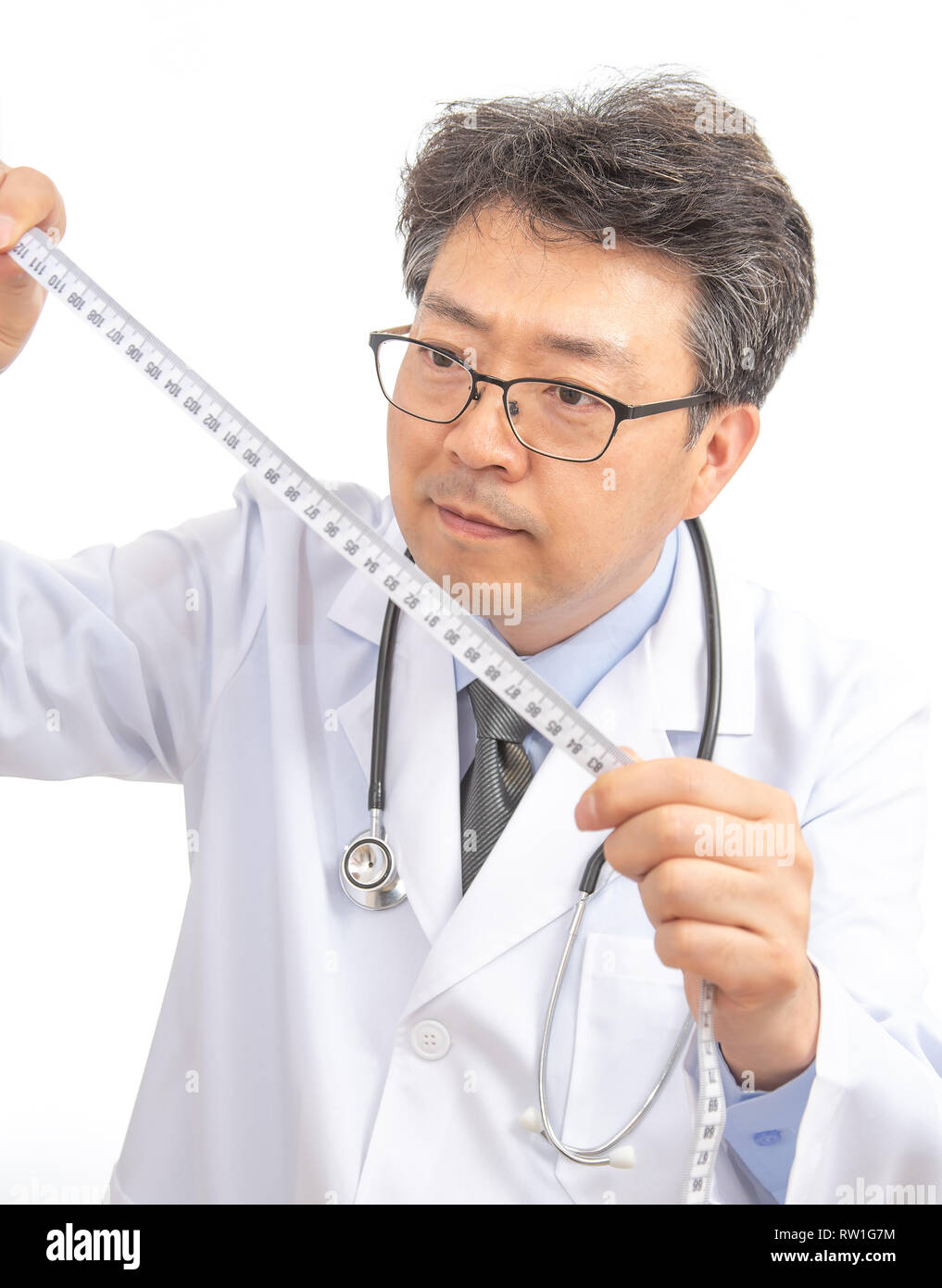 an Asian doctor with a tape measure in his hand. isolated on white ...