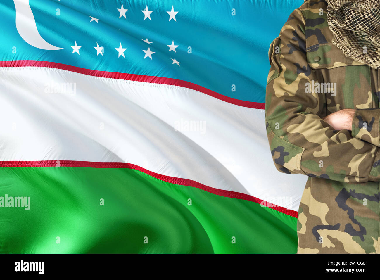 Crossed arms Uzbek soldier with national waving flag on background ...
