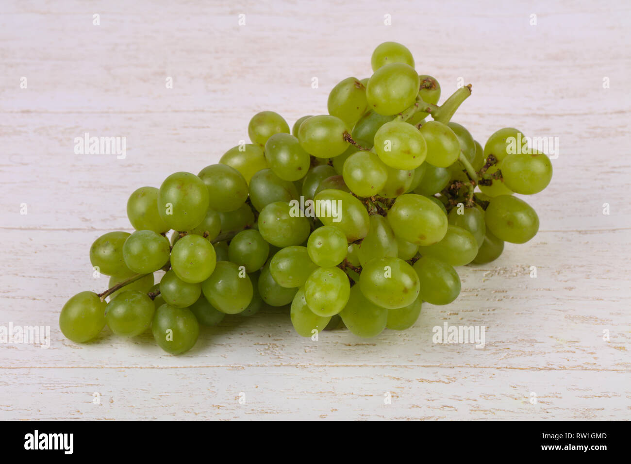 Sweet green grape branch over background Stock Photo - Alamy