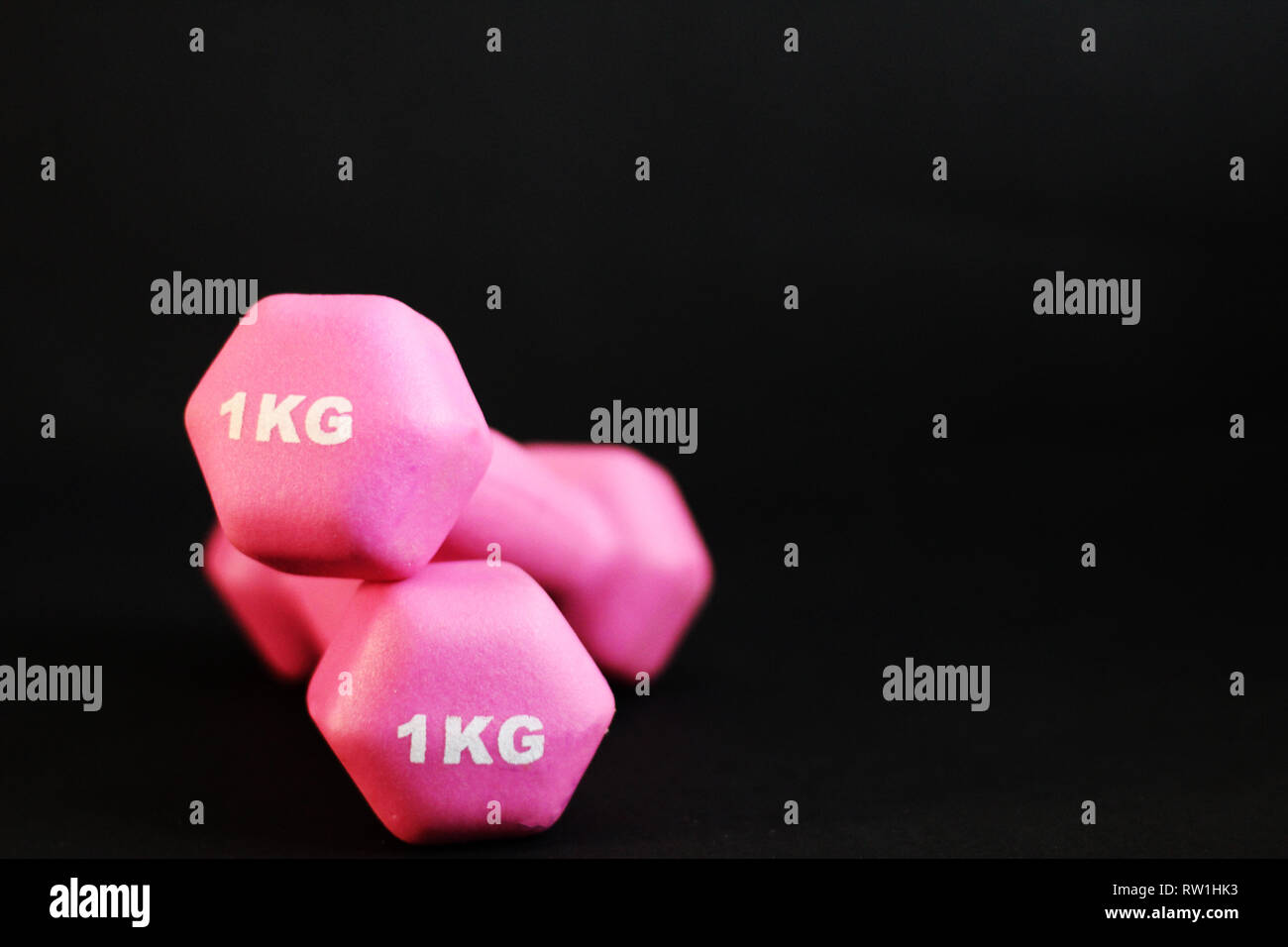 Two pink dumbbells closeup, black background, free copy space Stock ...