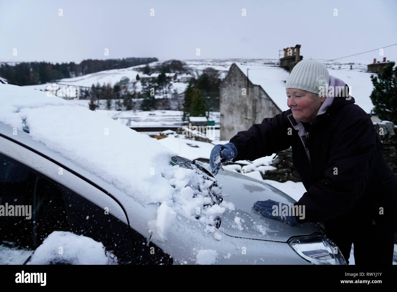 Hazel Kendrick, 78, clears snow in Nenthead, Cumbria following Storm ...