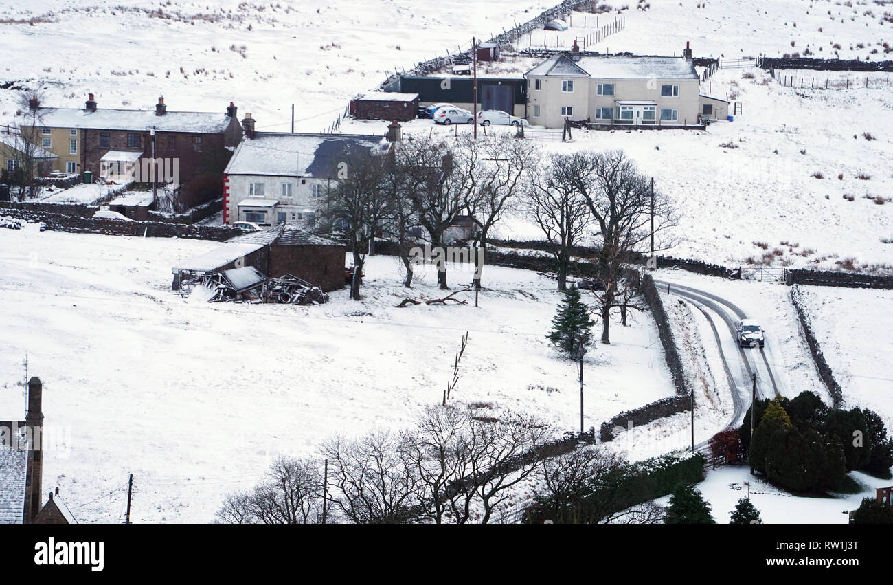 Car makes its way along snow covered road in nenthead hi-res stock ...
