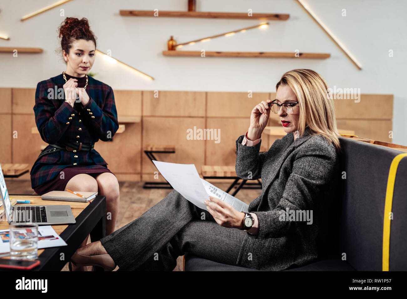 Boss wearing glasses reading working experience of employee Stock Photo ...