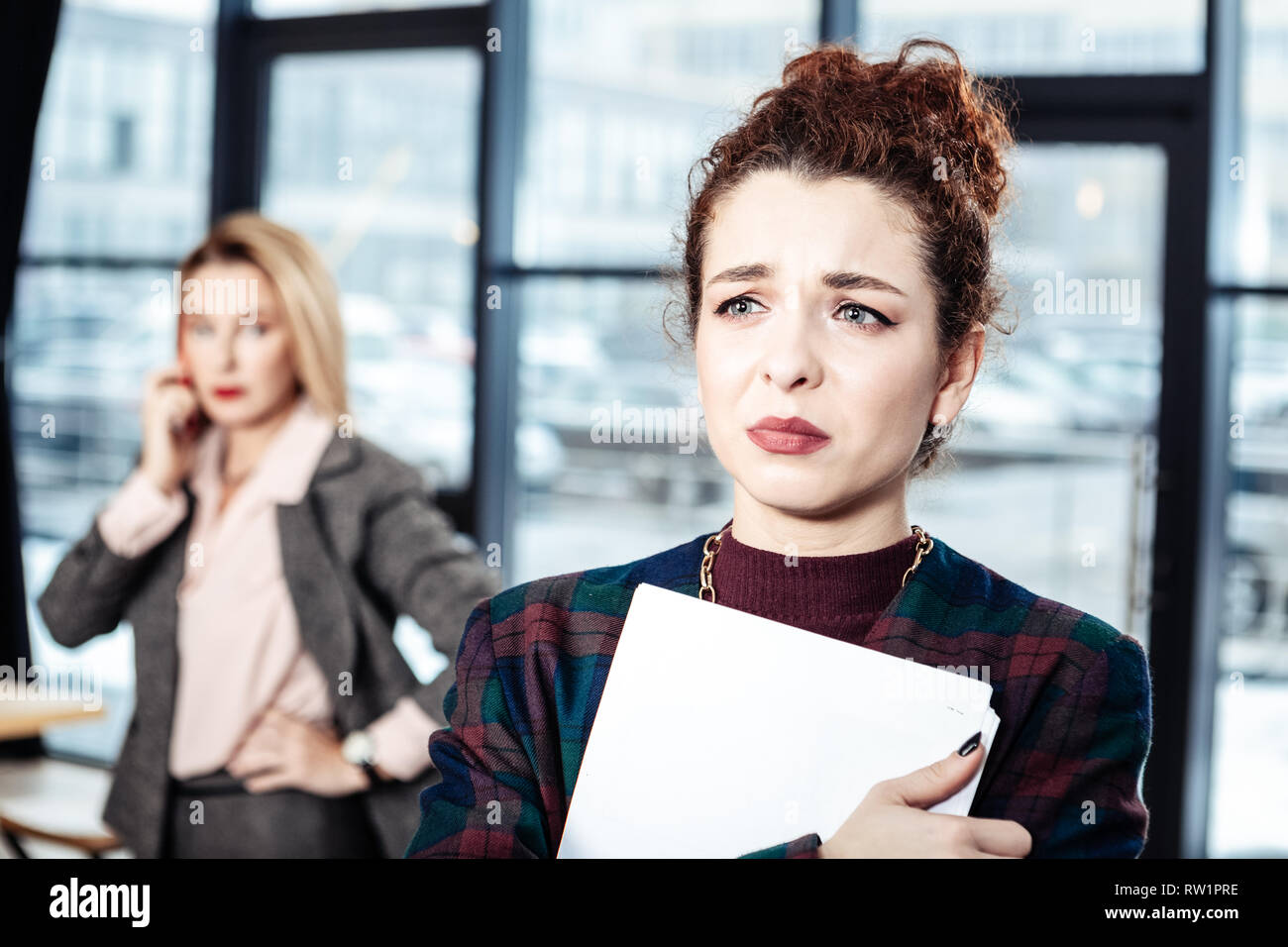 Secretary feeling overemotional after talking to strict boss Stock ... Secretary feeling overemotional after talking to strict boss Stock ...