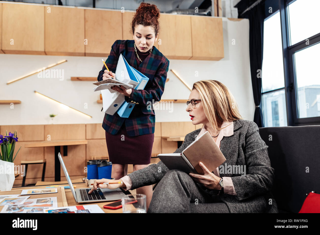 Secretary making notes while listening to instructions of boss Stock ...