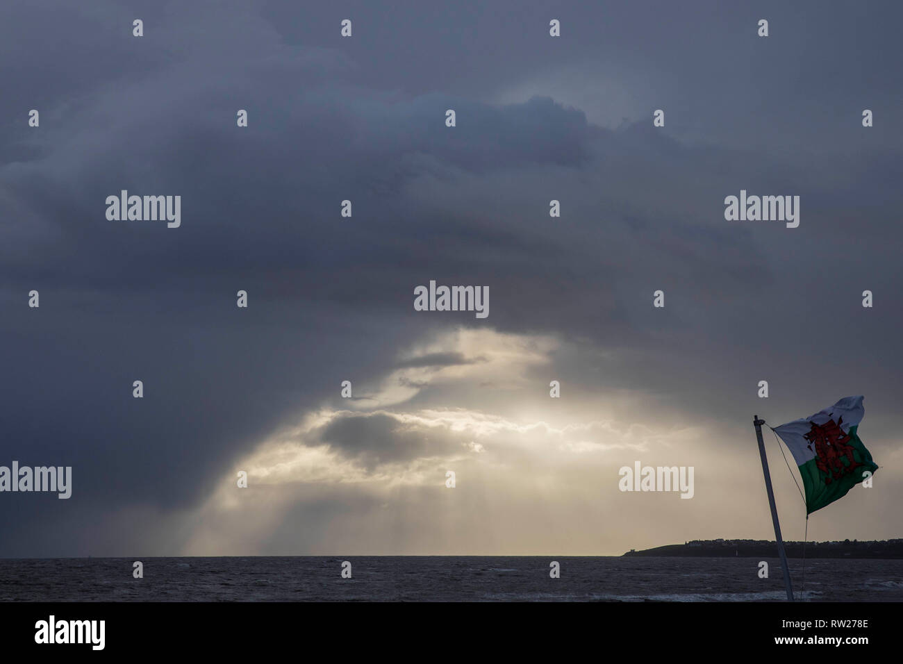 Sully, Wales, UK. March 4th 2019. A wind-beaten Welsh flag at a ...