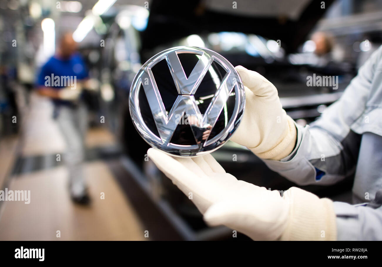 Wolfsburg, Germany. 01st Mar, 2019. An employee shows a VW logo shortly ...