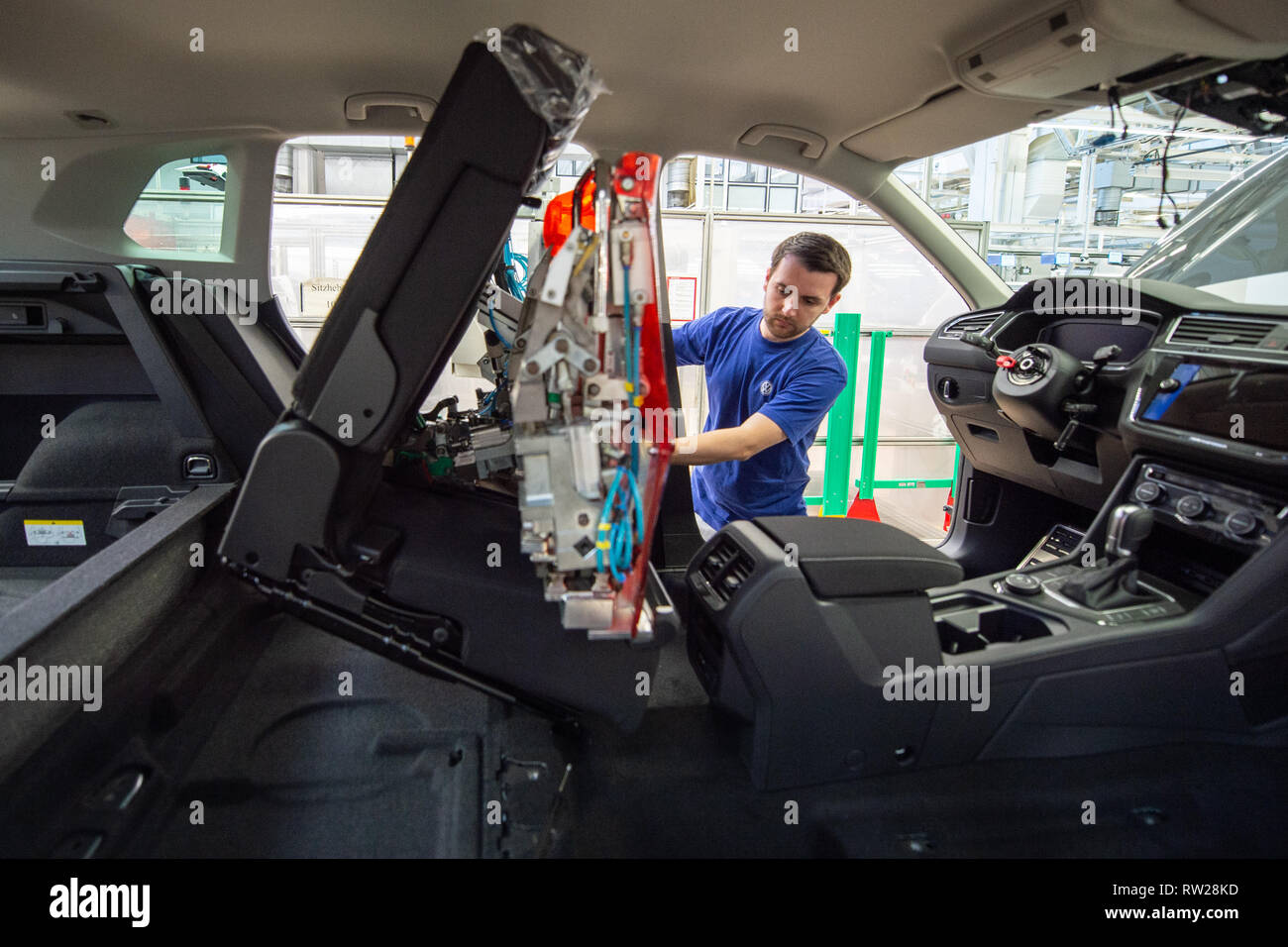 Wolfsburg, Germany. 01st Mar, 2019. An employee assembles a bench seat ...