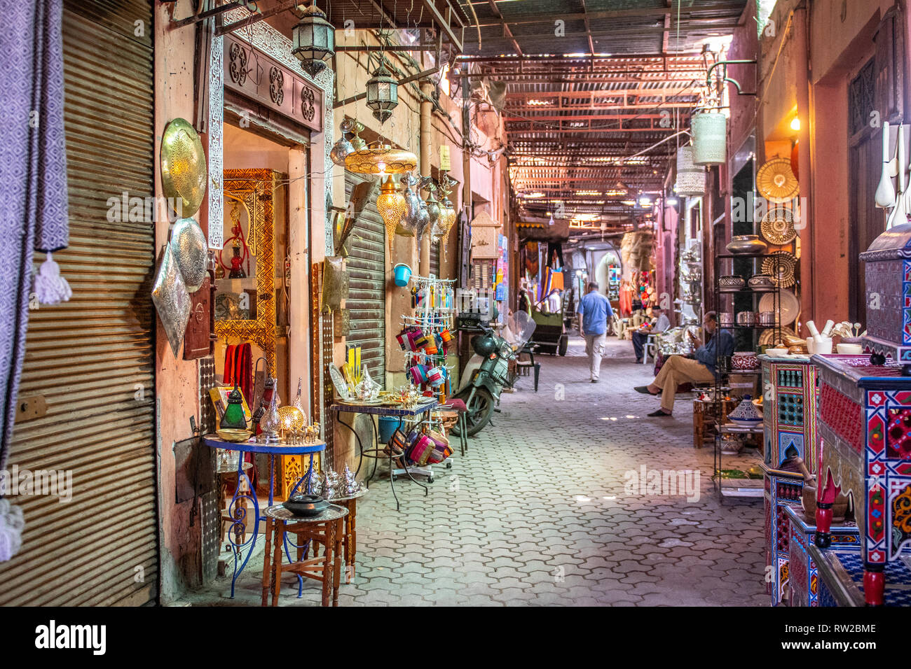 Market stalls selling a goods line narrow walkway in covered souk ...