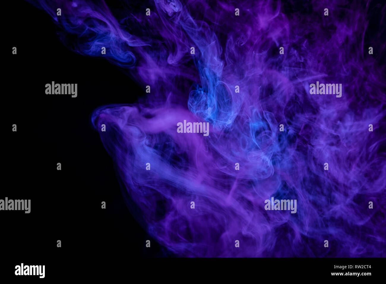 Thick colorful blue smoke on a black isolated background. Background ...