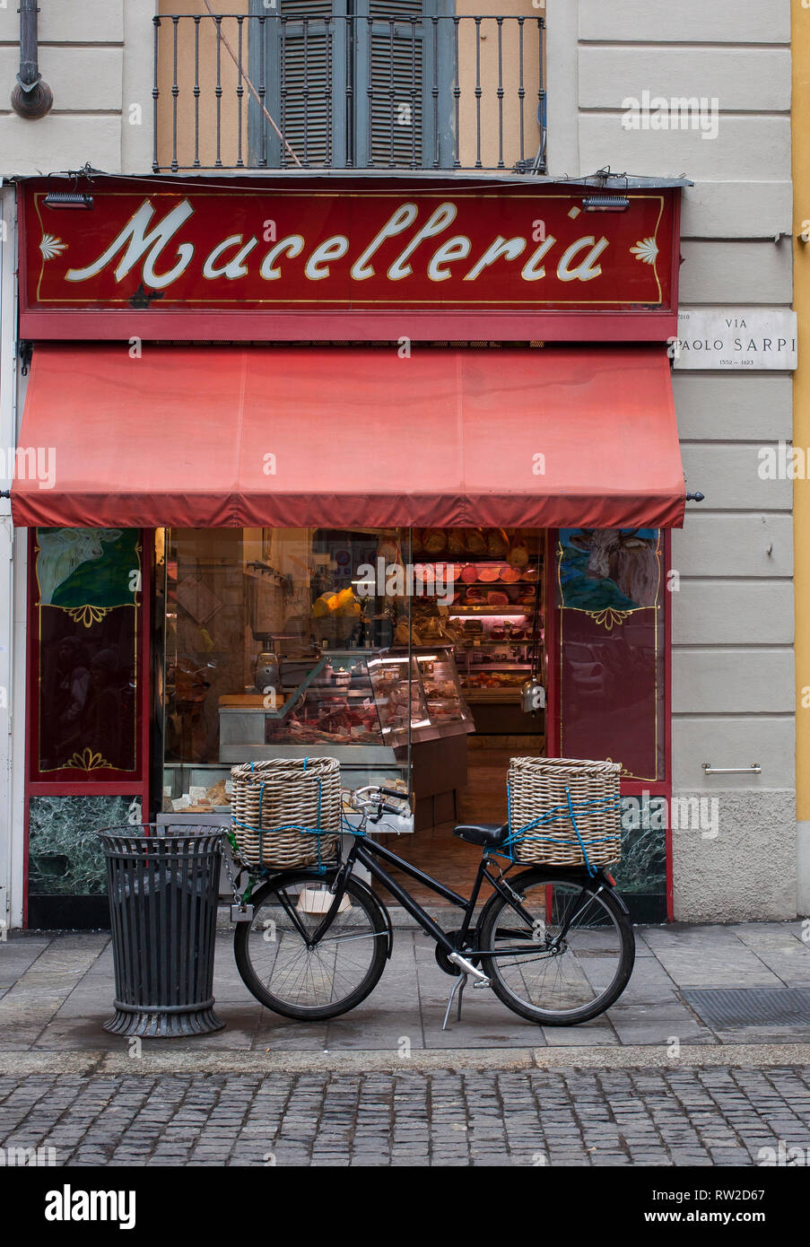 Bike next to a typical italian Butcher's shop, Milan Stock Photo - Alamy