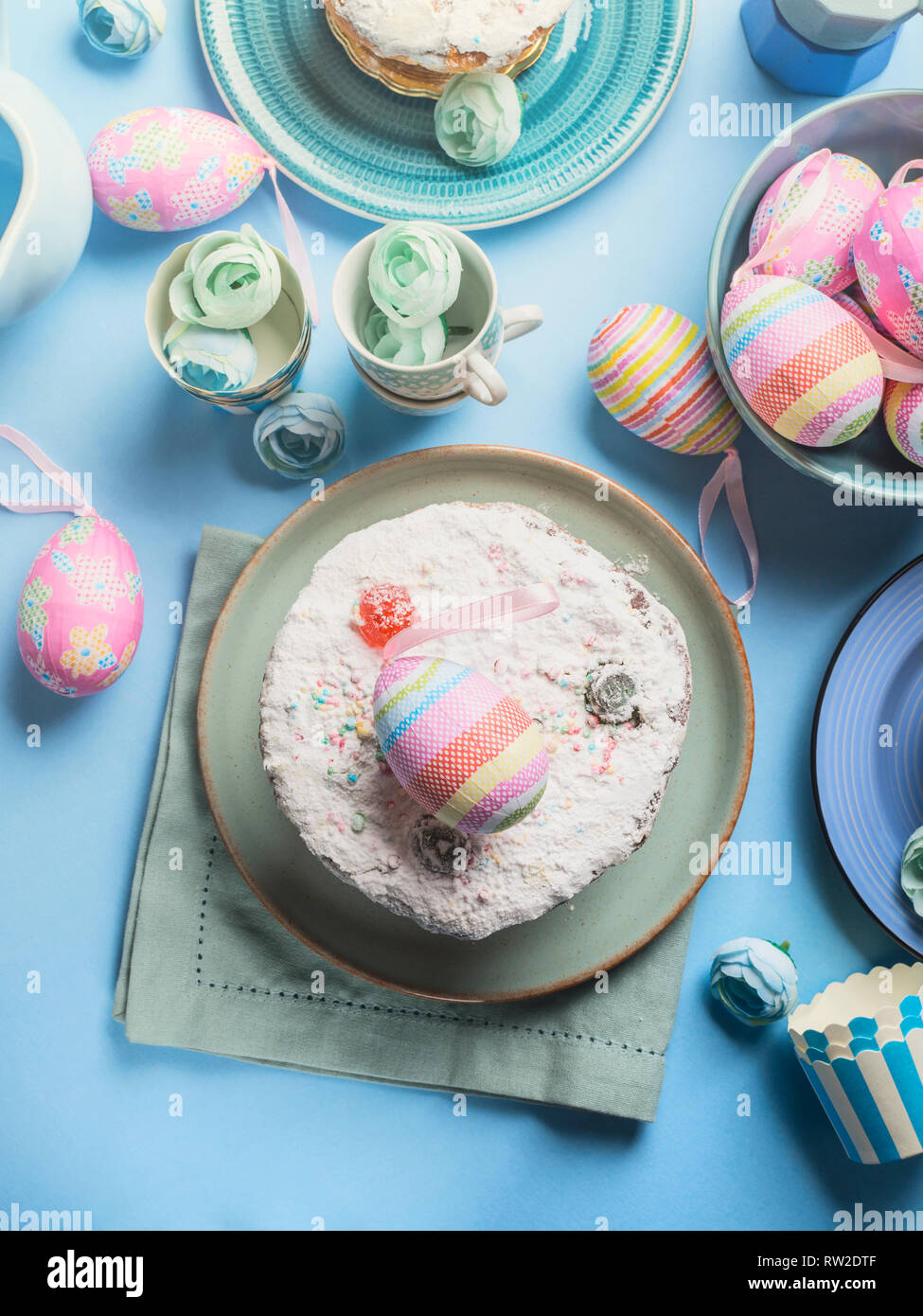 Easter concept background with cake and decor eggs on minimal blue ...