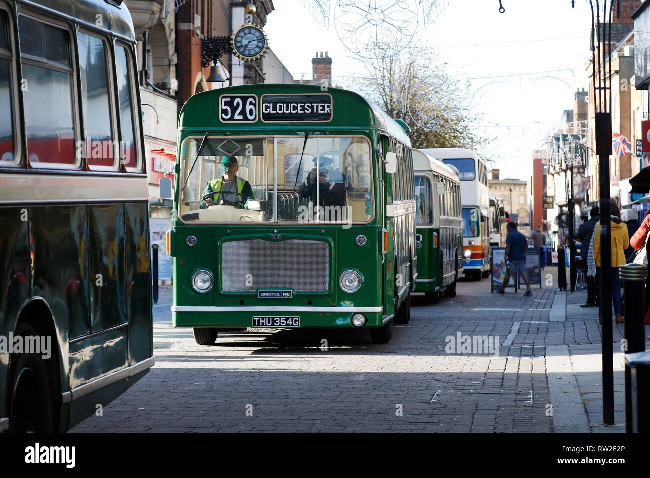 A cavalcade of 20 classic buses driving through Gloucester city centre ...