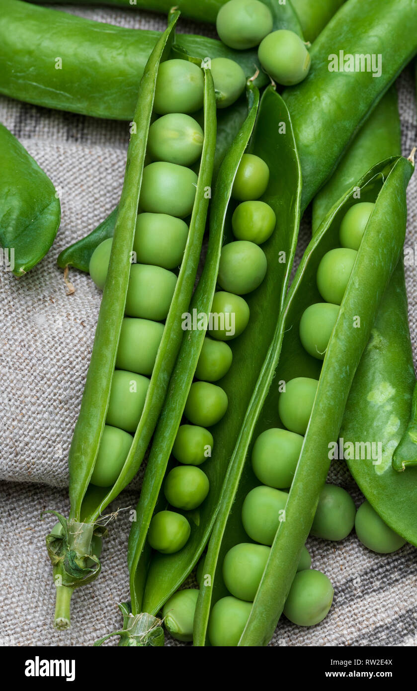 Green, tender, fresh and raw peas. Close-up and top view. Rustic ...