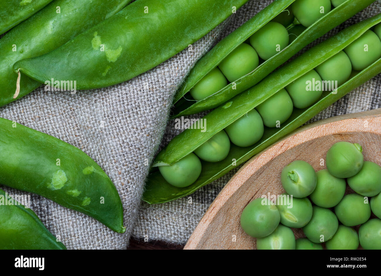 Green, tender, fresh and raw peas. Close-up and top view. Rustic ...