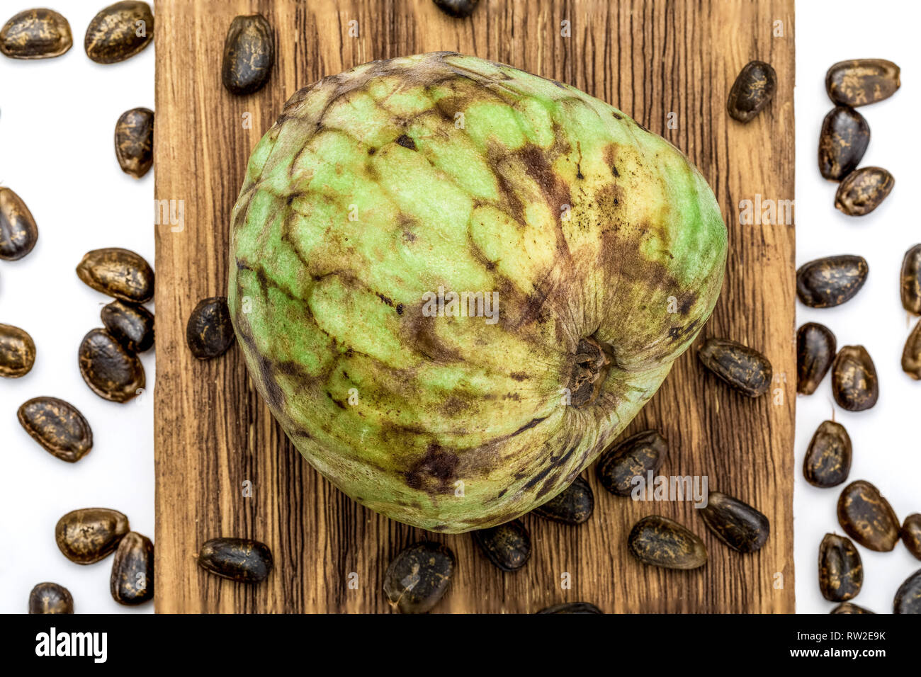 Mature cherimoya. Whole fruit and nuggets on wooden and white ...
