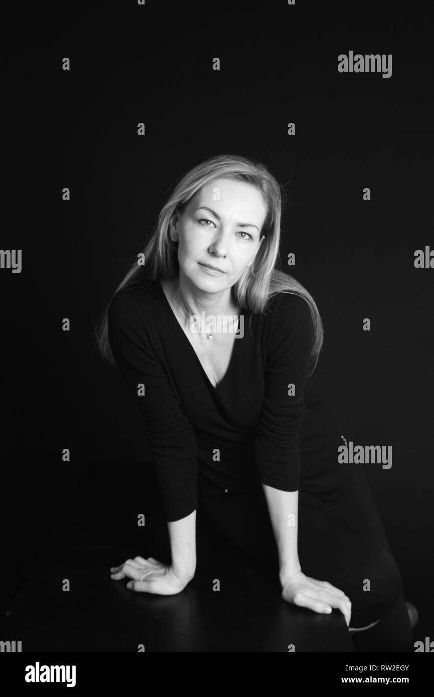 Close up studio portrait of a beautiful woman in the black dress ...
