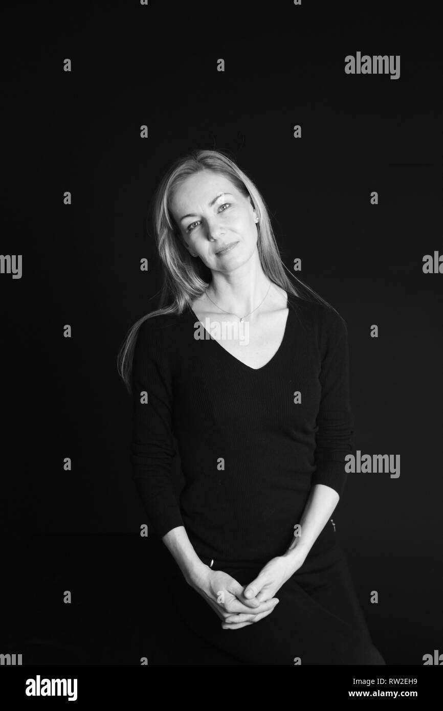 Close up studio portrait of a beautiful woman in the black dress ...