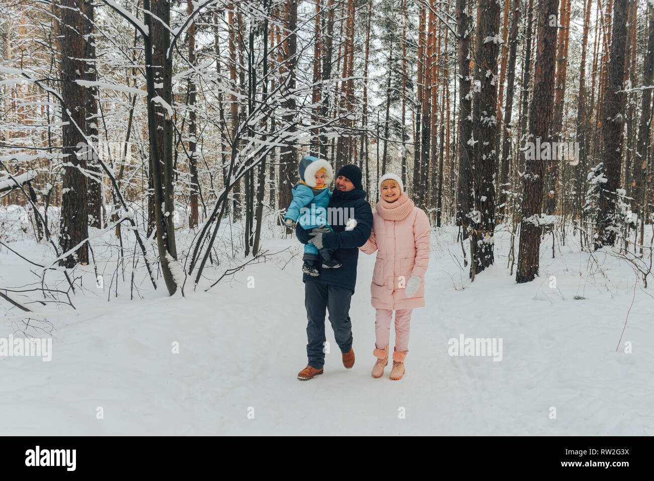 Walking family with a child. Family walks in nature in winter. Winter ...
