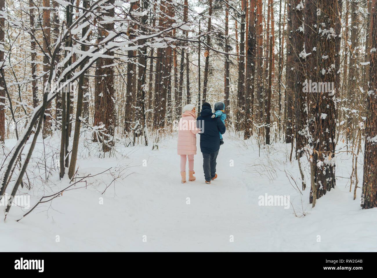 Walking family with a child. Family walks in nature in winter. Winter ...