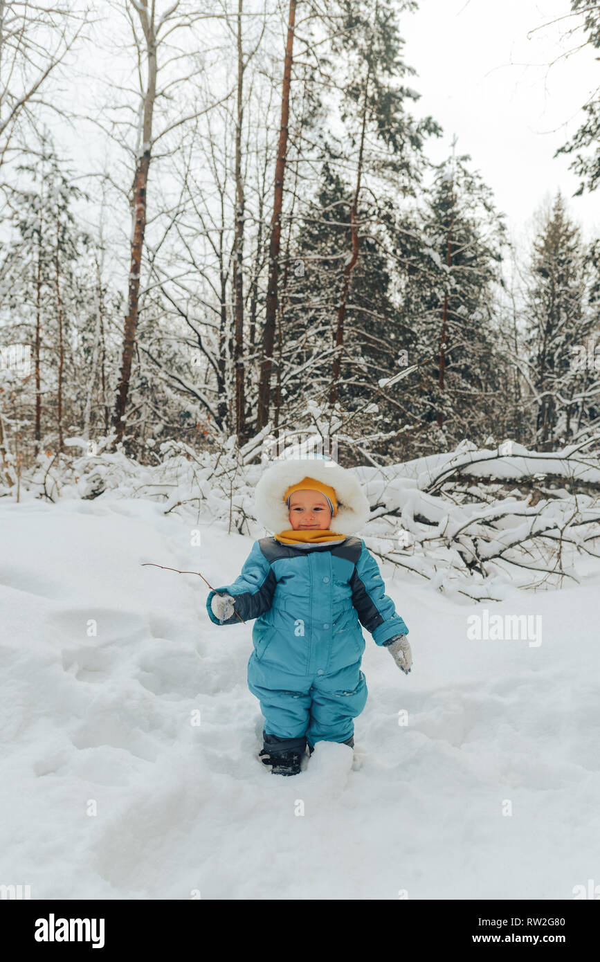 A child for a walk in the winter. Kid in winter clothes. Family walks ...