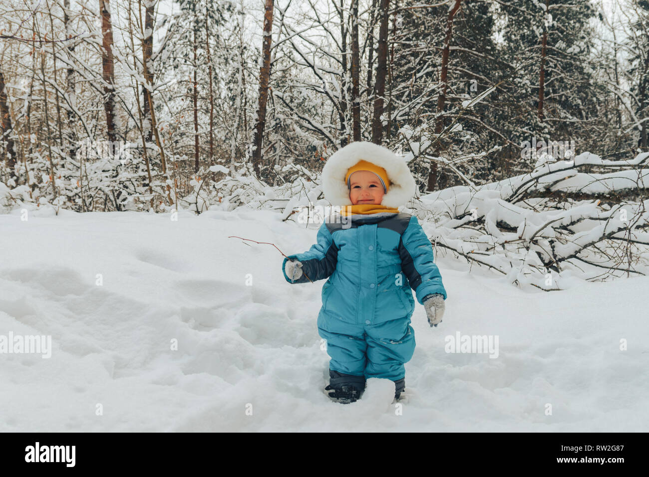 A child for a walk in the winter. Kid in winter clothes. Family walks ...