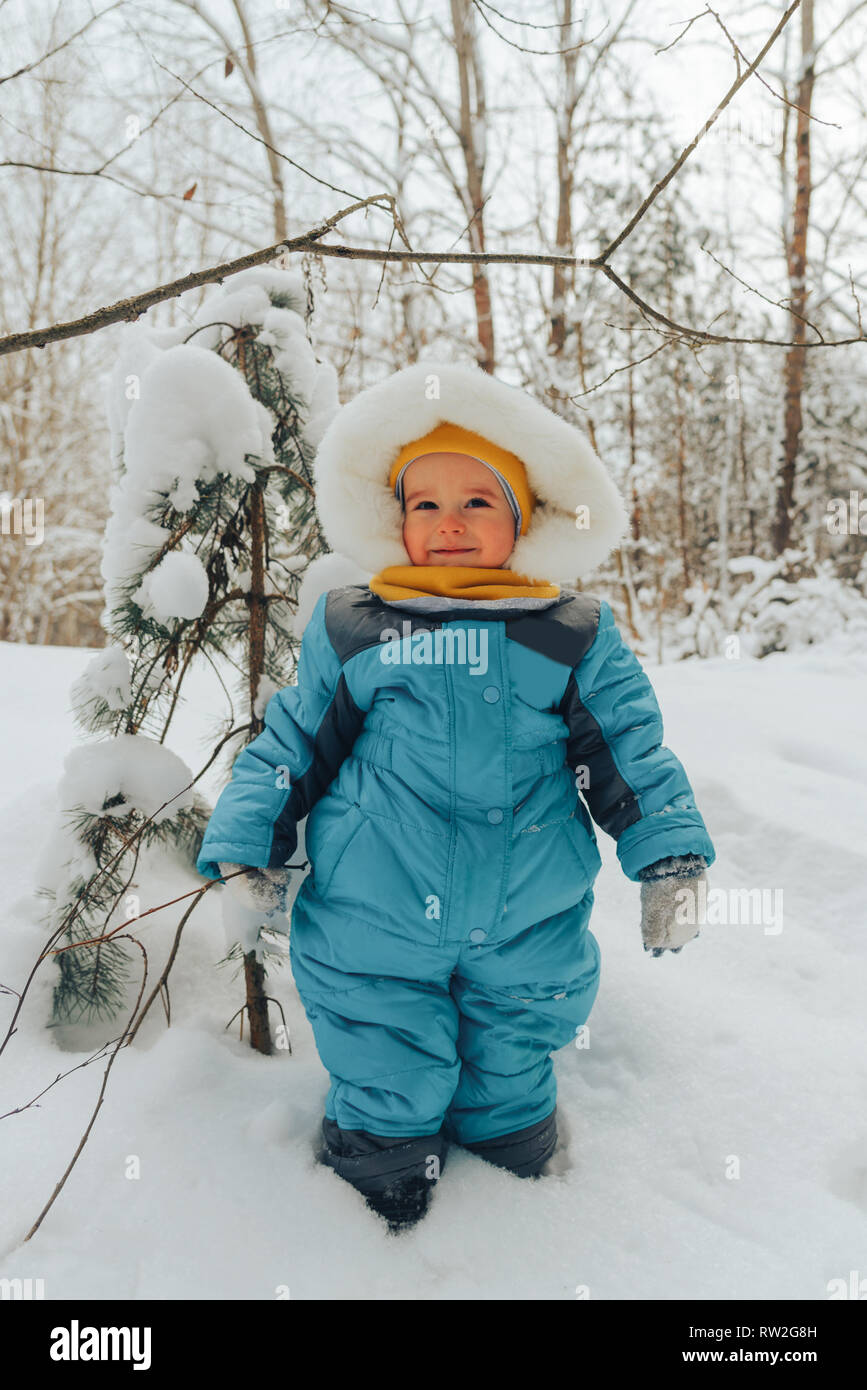 A child for a walk in the winter. Kid in winter clothes. Family walks ...