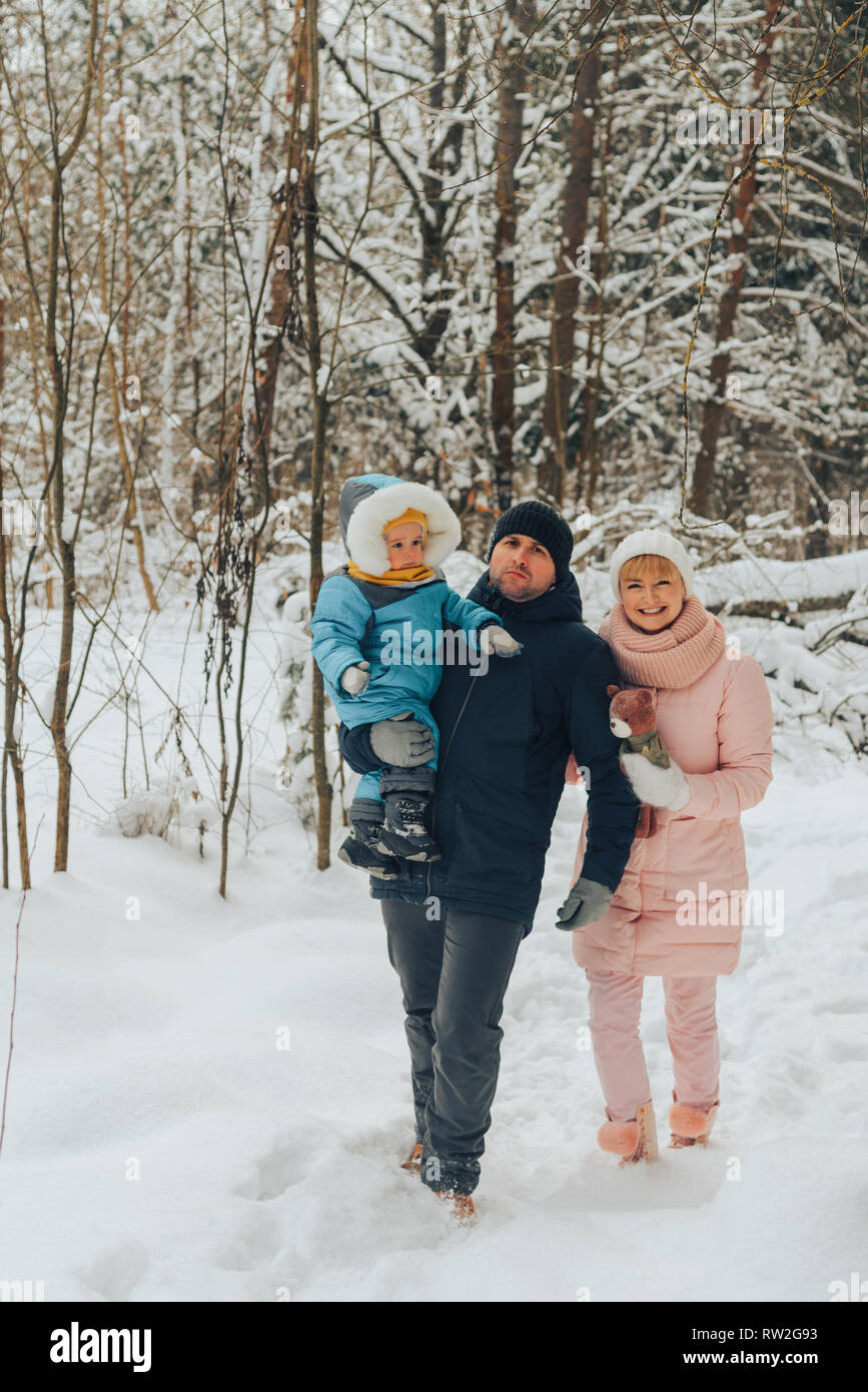 Walking family with a child. Family walks in nature in winter. Winter ...