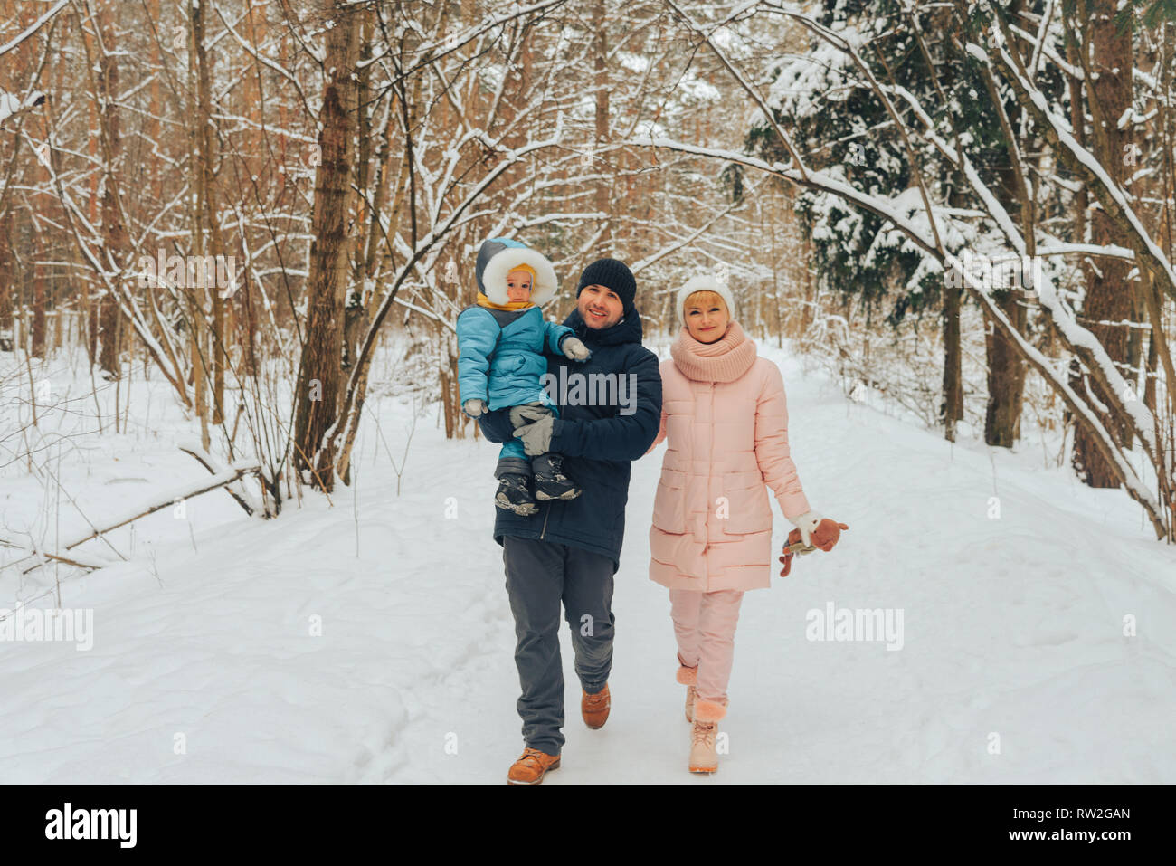 Walking family with a child. Family walks in nature in winter. Winter ...