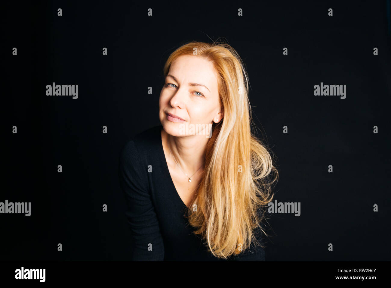 Close up studio portrait of a beautiful woman in the black dress ...