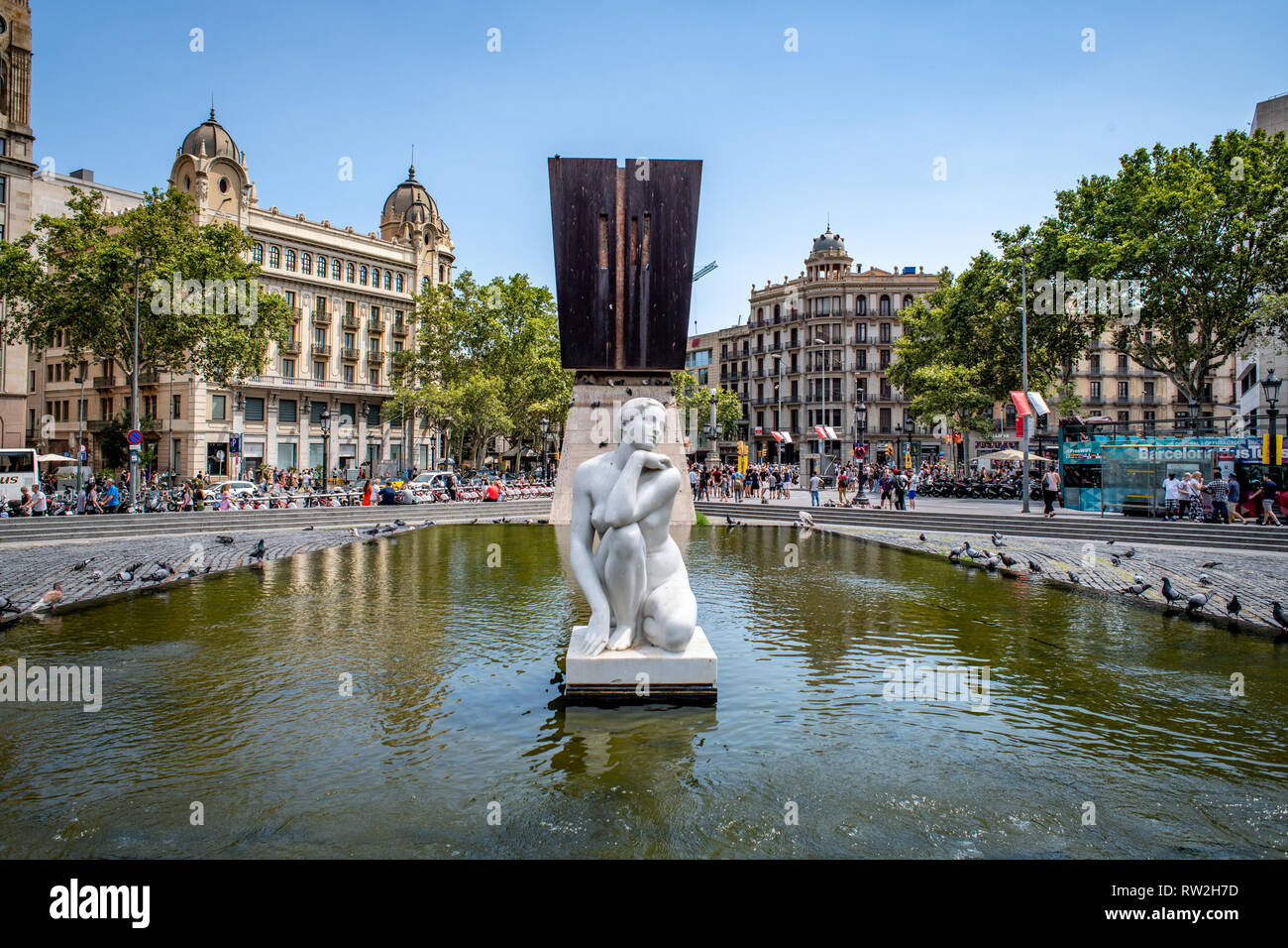 A beautiful statue in the middle of a fountain Pla a de Catalunya ...